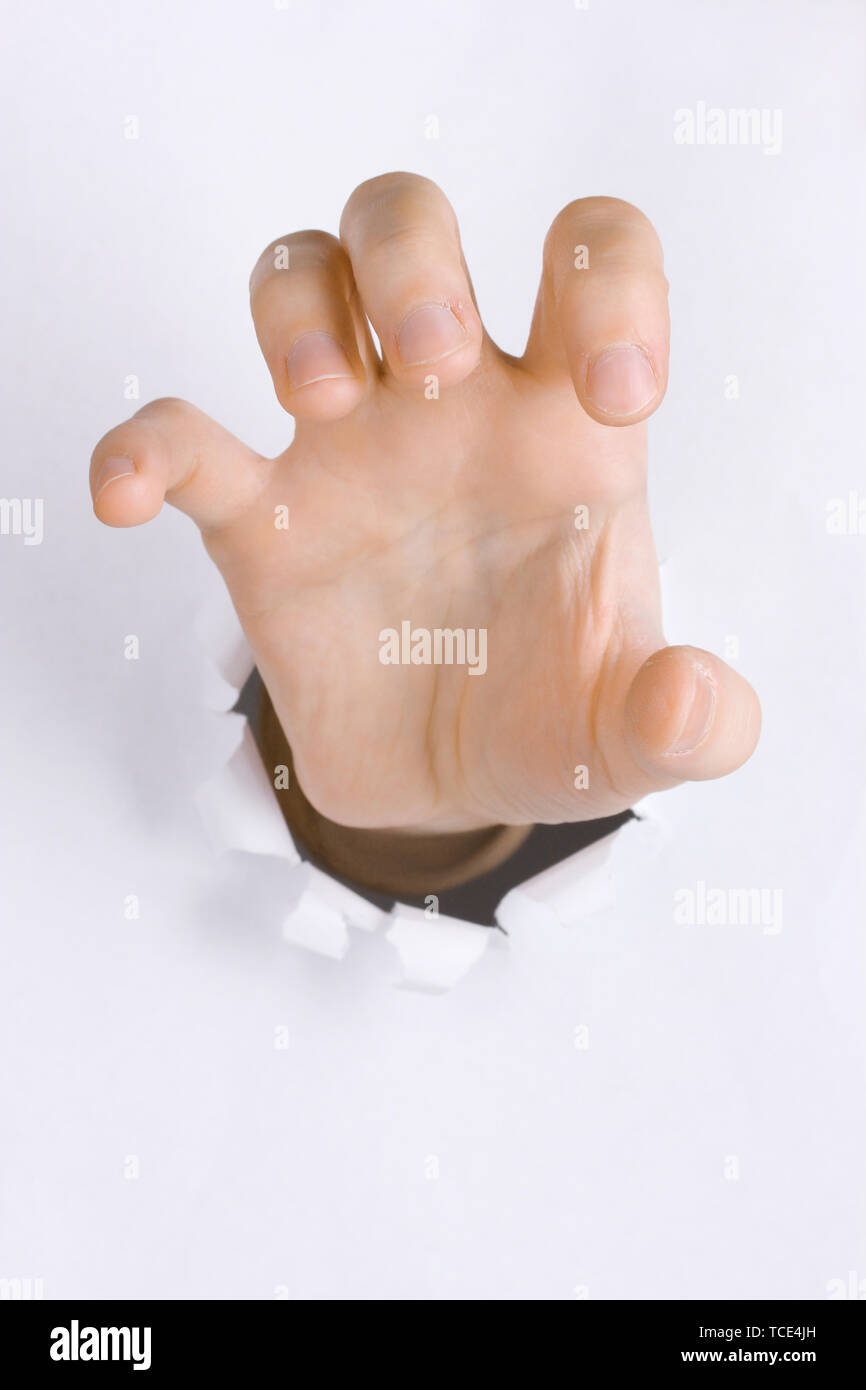 Hand breaking through the paper Stock Photo - Alamy