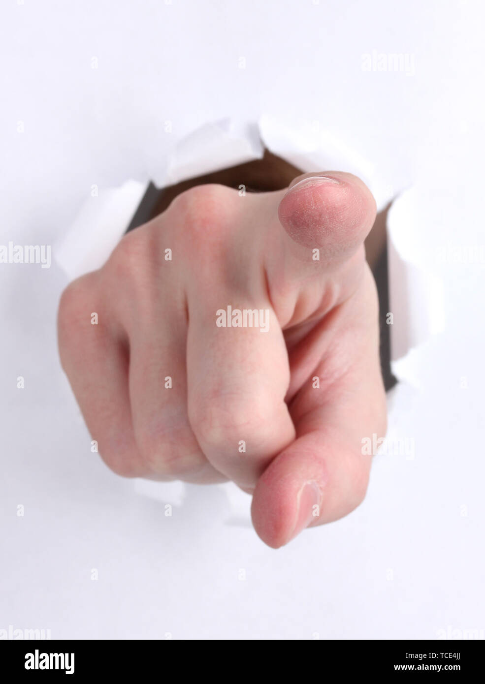 Pointing hand breaking through the paper Stock Photo - Alamy