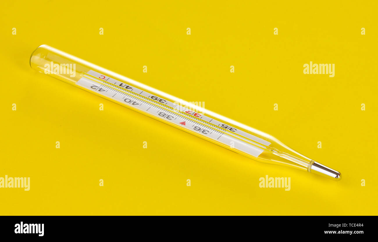 thermometer on a yellow background Stock Photo - Alamy