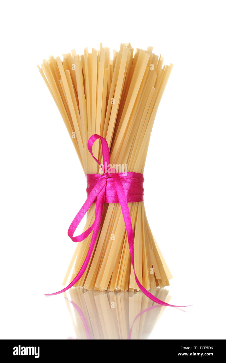 Bunch of spaghetti with ribbon isolated on white Stock Photo - Alamy