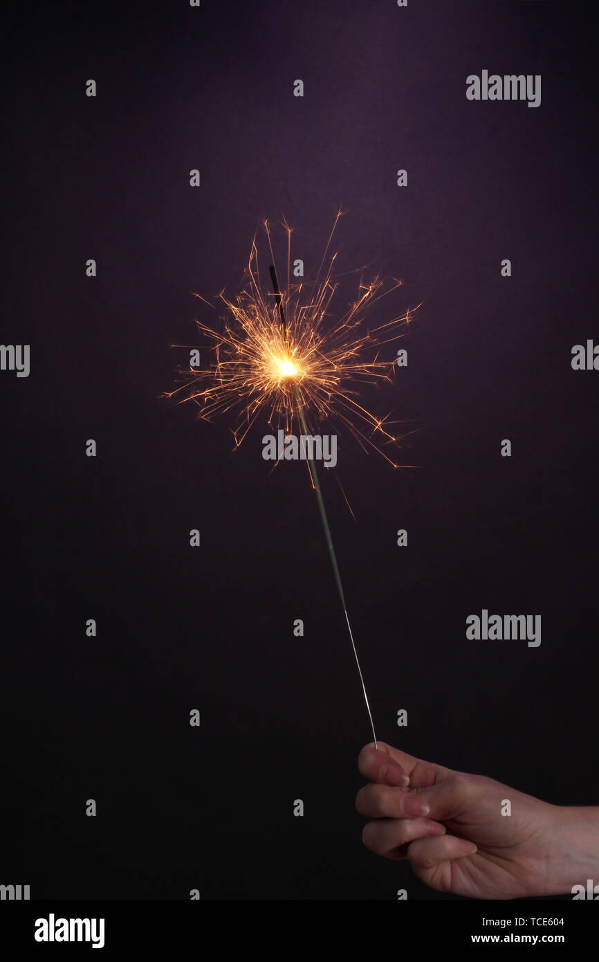 beautiful sparkler on purple background Stock Photo - Alamy