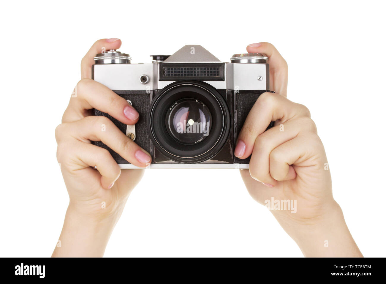 Old photo camera in hands isolated on white Stock Photo - Alamy