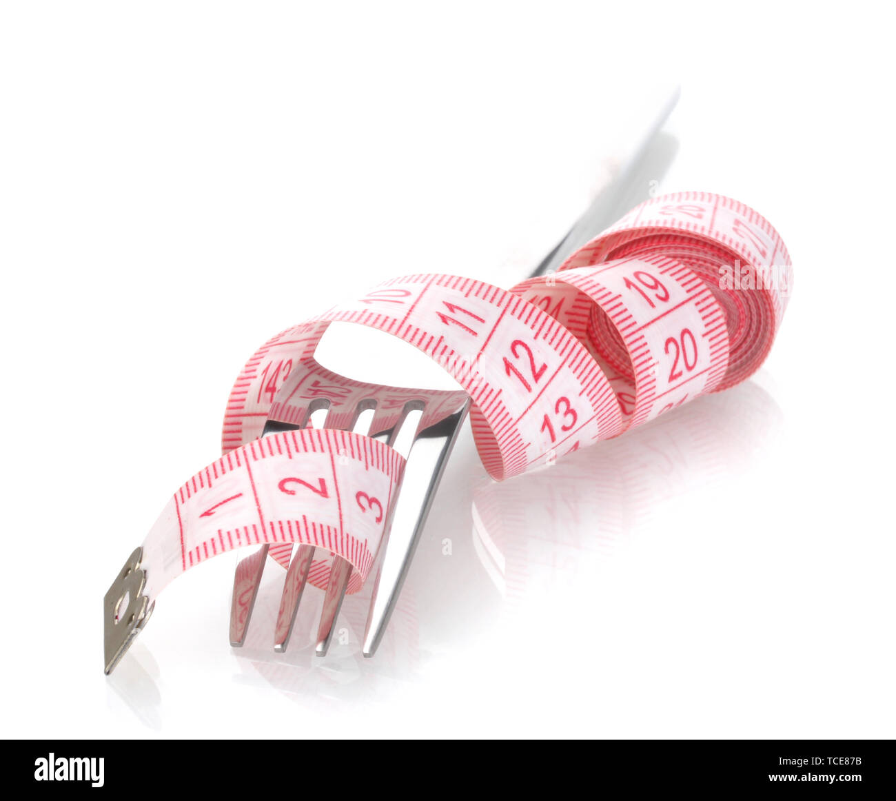 Fork and measuring tape isolated on white Stock Photo - Alamy