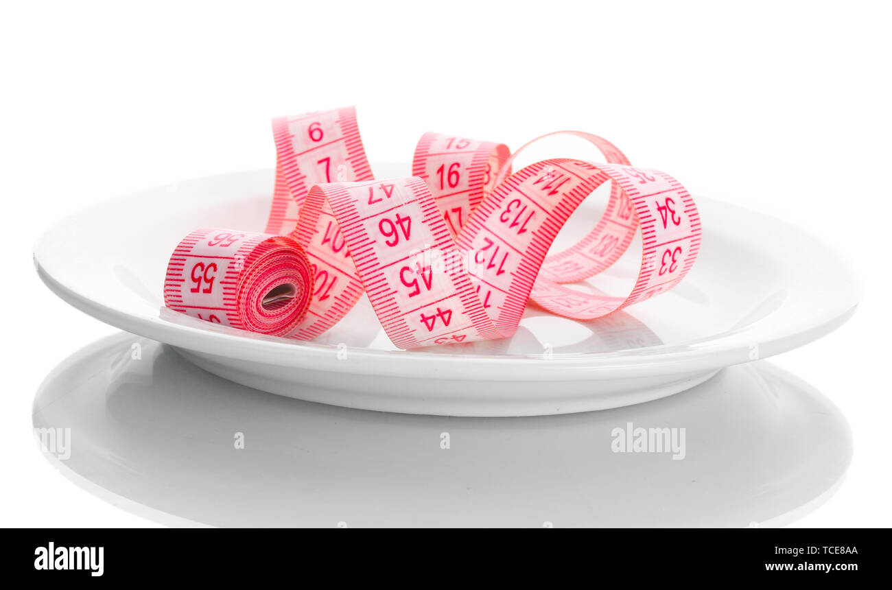 measuring tape on plate isolated on white Stock Photo - Alamy