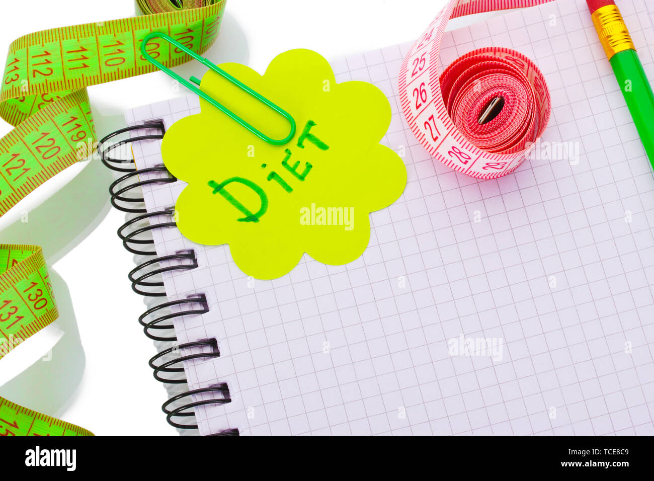 Planning of diet. Notebook measuring tapes and pen isolated on white ...