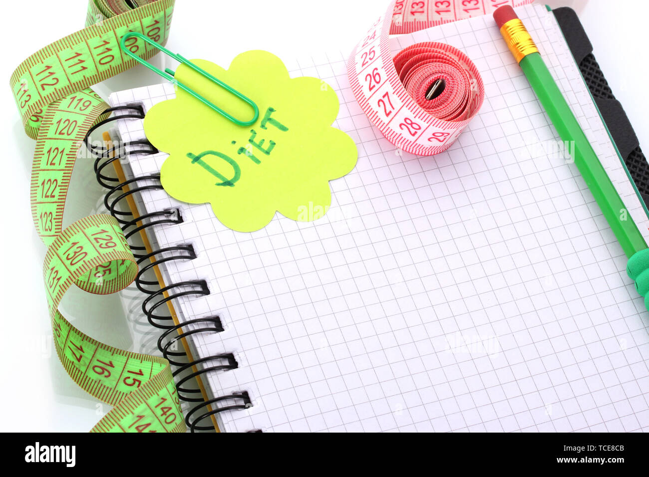 Planning of diet. Notebook measuring tapes and pen isolated on white ...