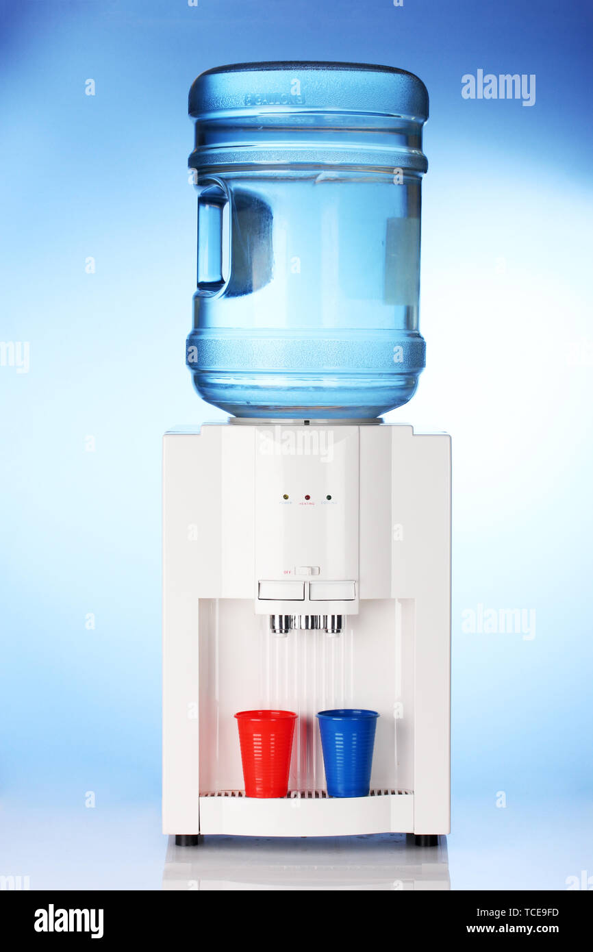 Electric water cooler on blue background Stock Photo - Alamy