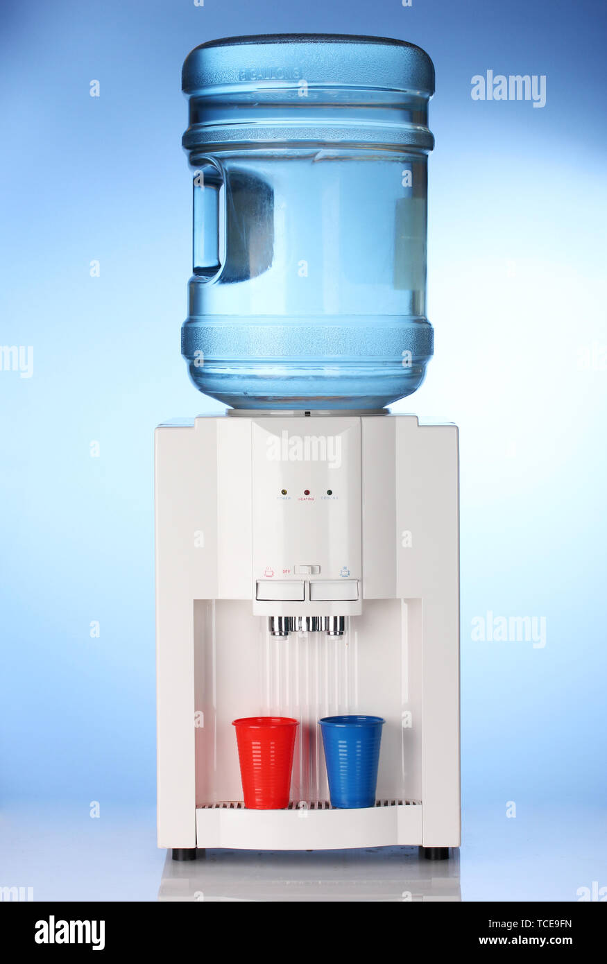Electric water cooler on blue background Stock Photo - Alamy