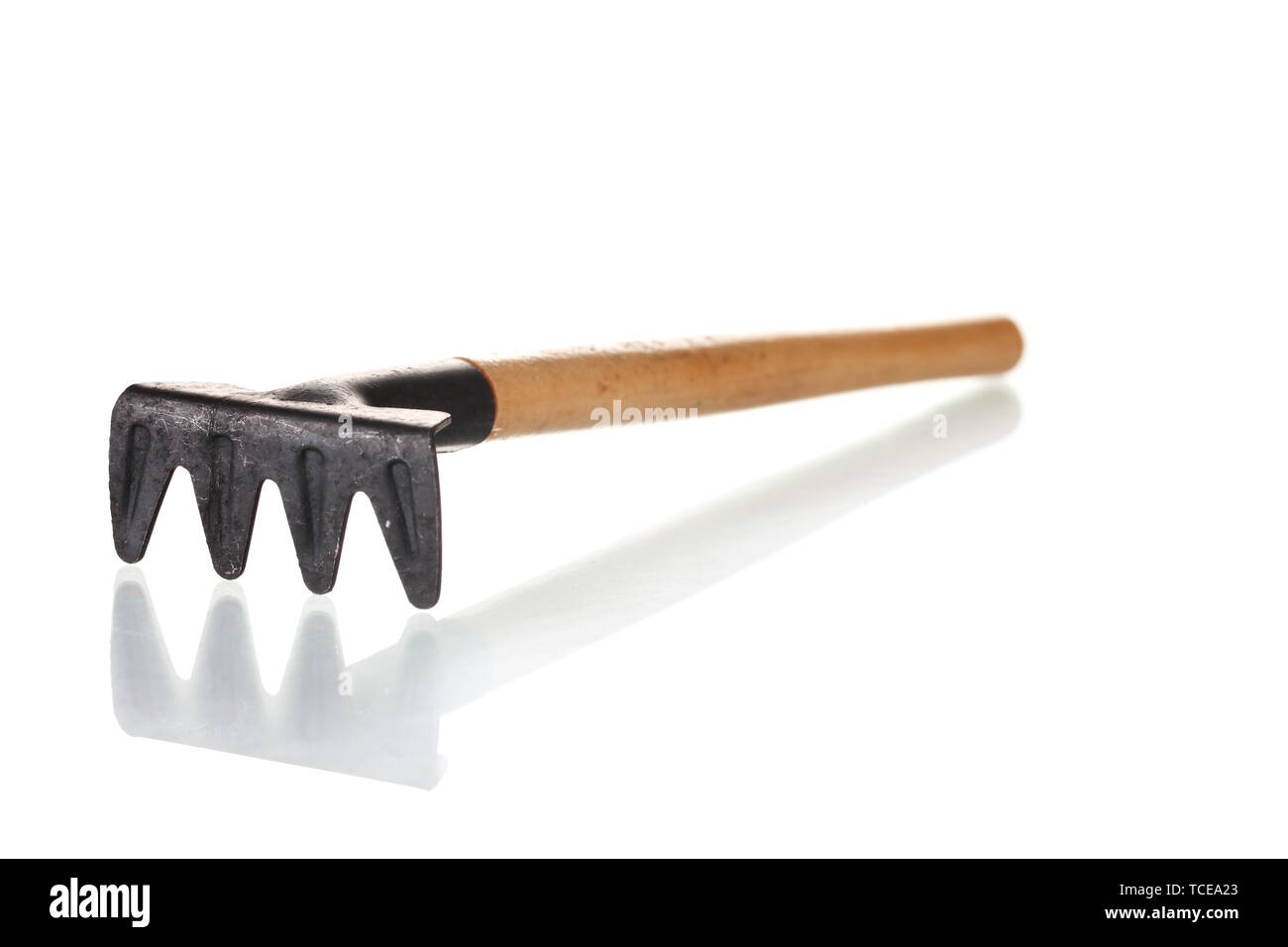 Garden rake isolated on white Stock Photo - Alamy