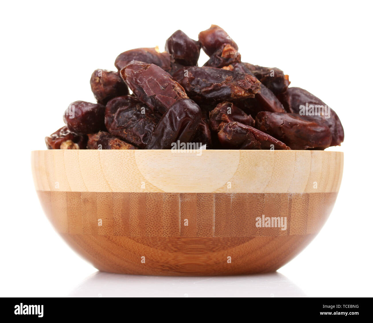 delicious dried dates in wooden bowl isolated on white Stock Photo - Alamy