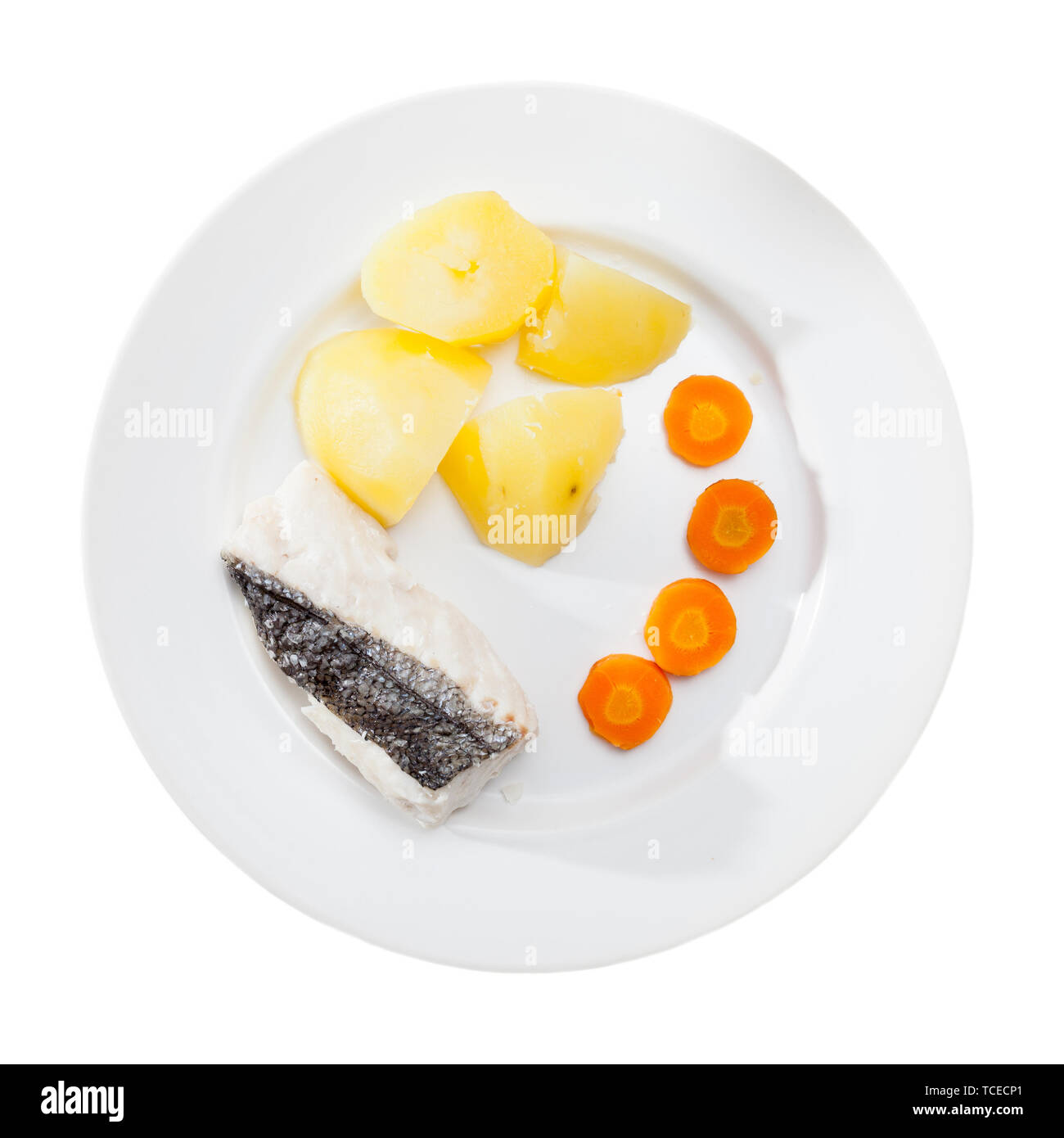 Top view of steamed hake fillet served on white plate with boiled ...