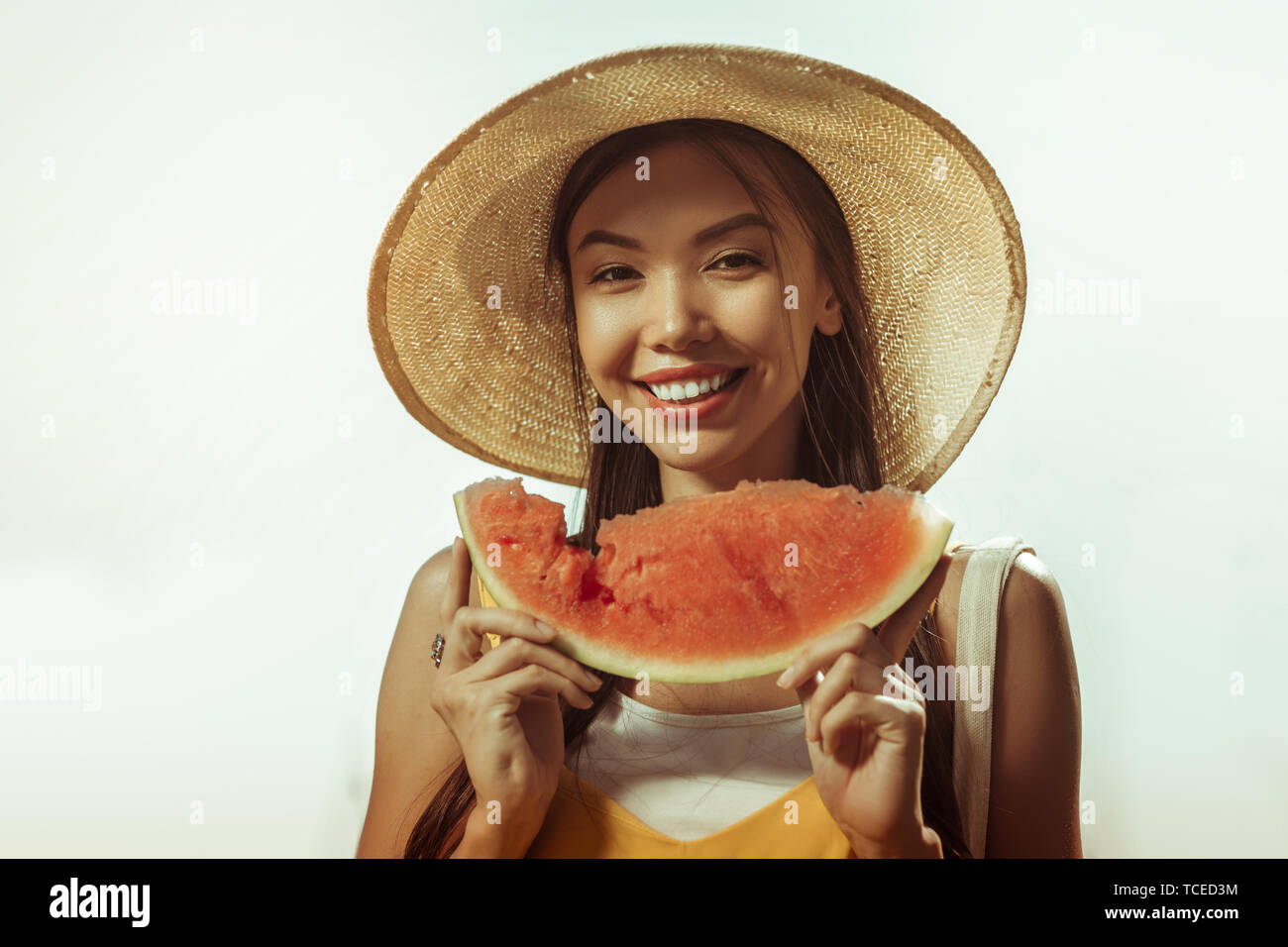 Watermelon piece in hands. Close-up face portrait of alluring pleasing ...