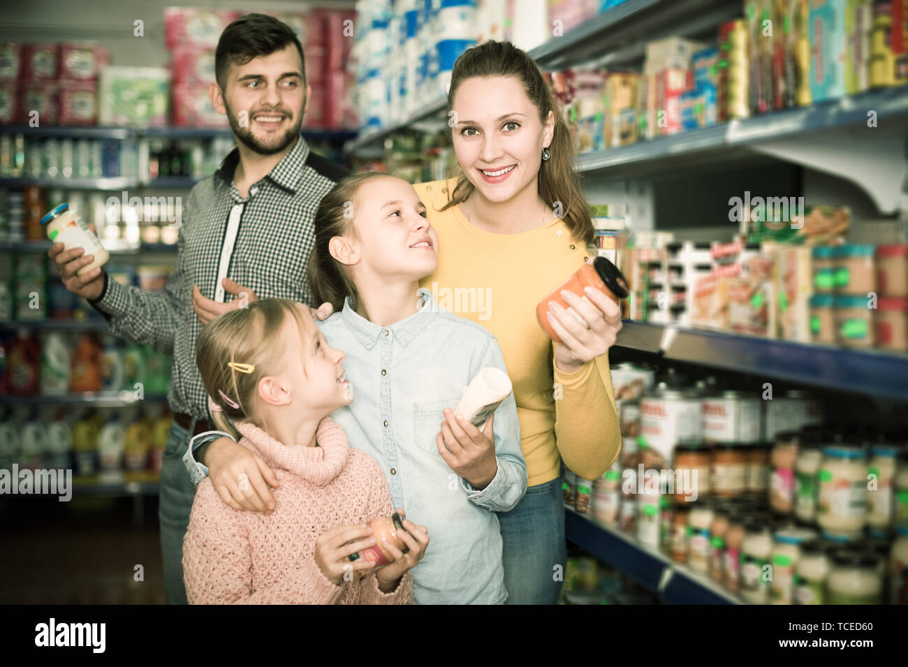 adult family of four shopping together in grocery store Stock Photo - Alamy