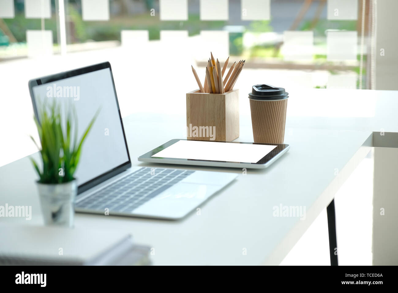 computer tablet pencil coffee cup on office desk. workplace co-working ...