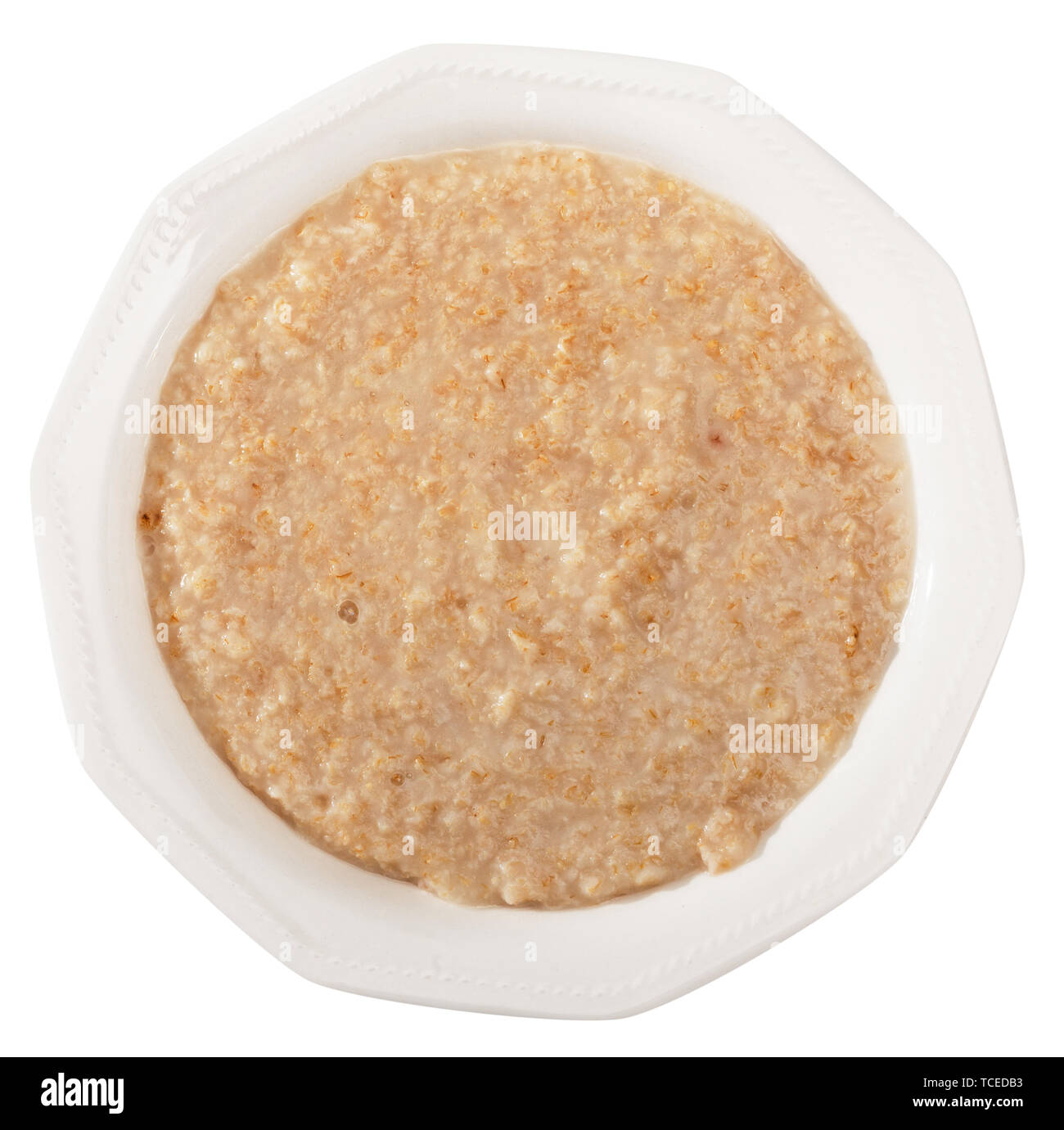 Top view of boiled oatmeal porridge served in white plate. Concept of ...