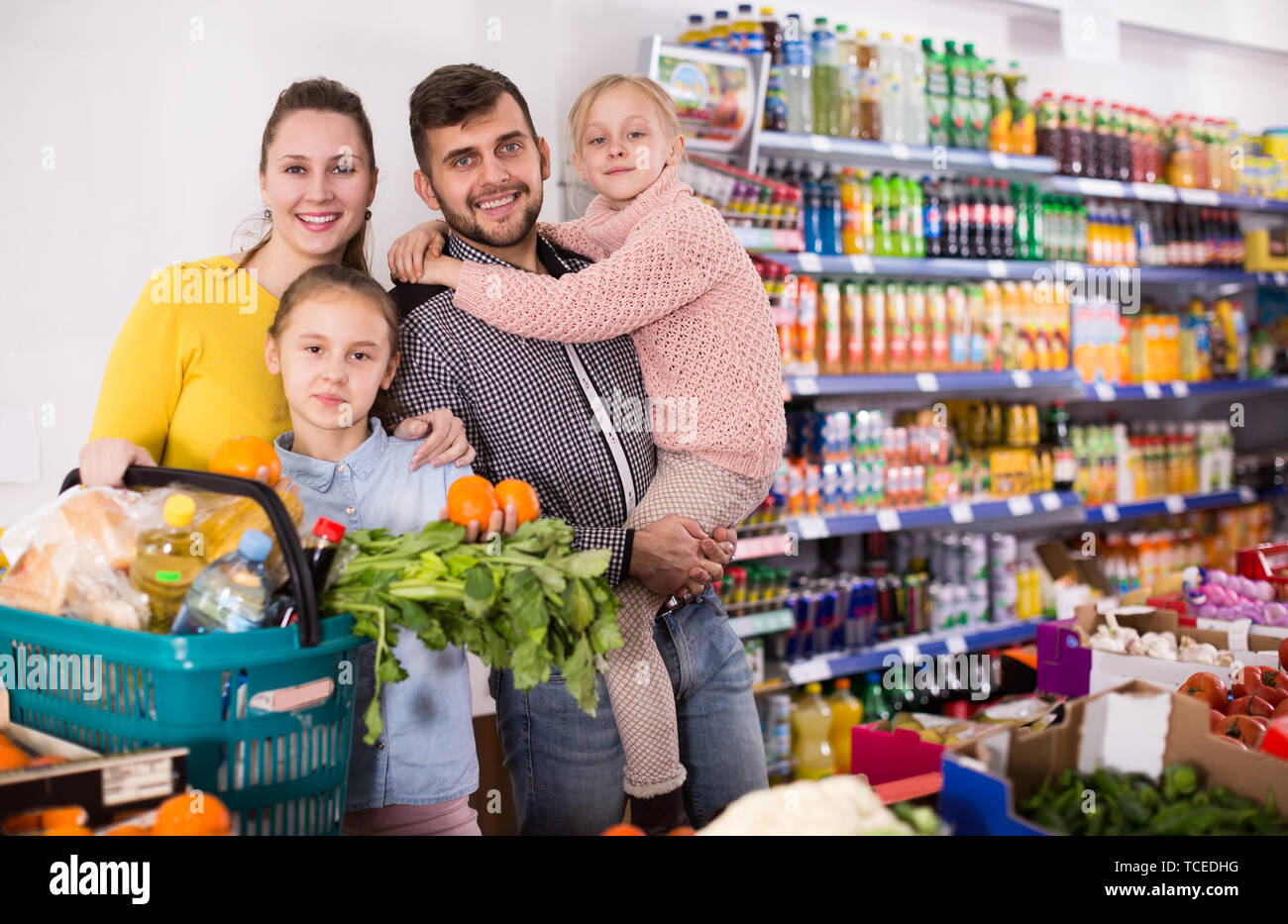 Cheerful family customers during family shopping in vegetable ...