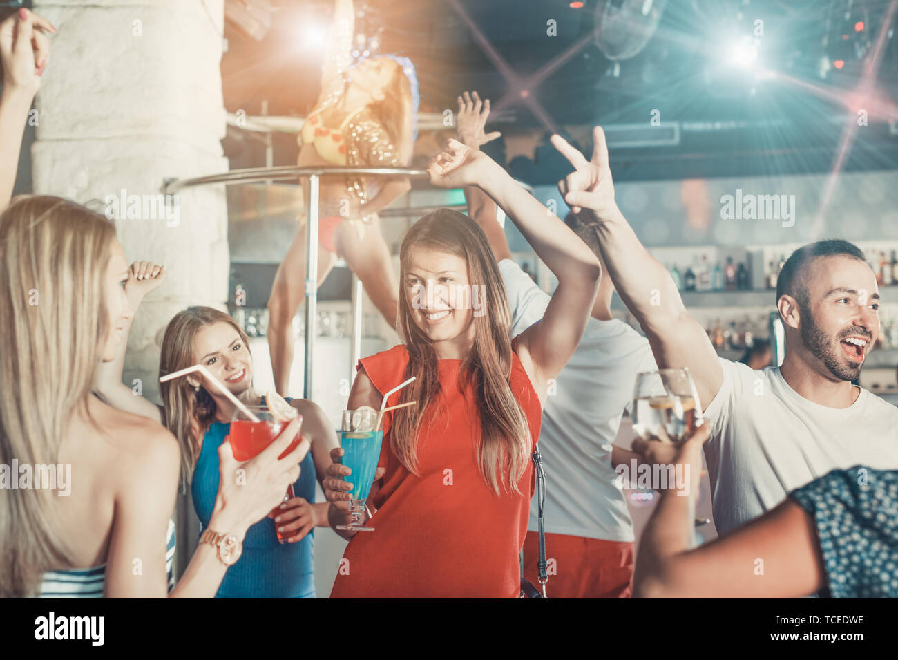 Group of smiling people clubbing in a night club with drinks Stock ...