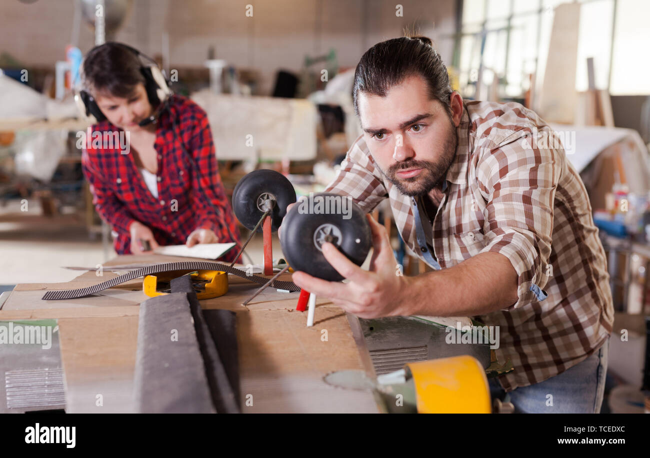 Male aircraft enthusiast working in workshop on creating of airplane ...