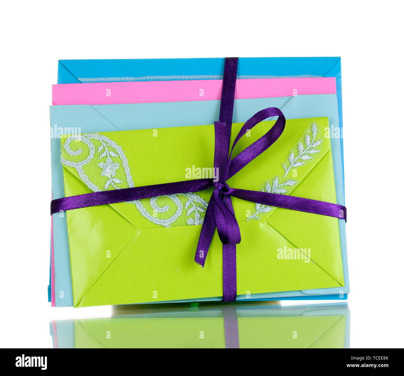 Bunch of color envelopes with ribbon isolated on white Stock Photo - Alamy
