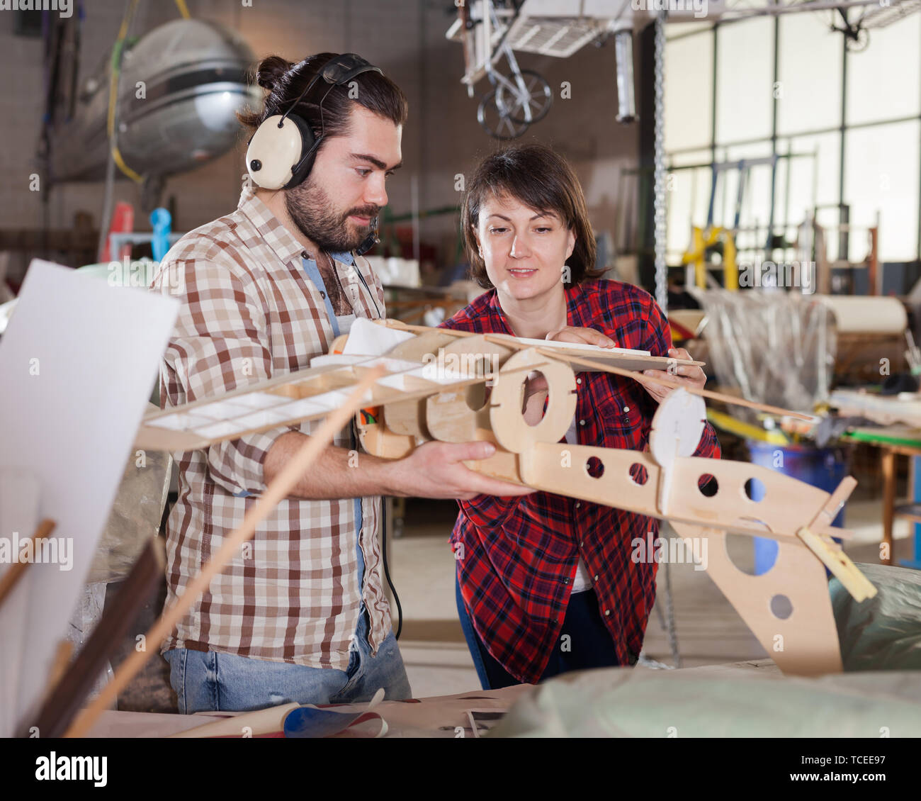 Positive couple enjoying their hobbies - modeling light airplanes in ...