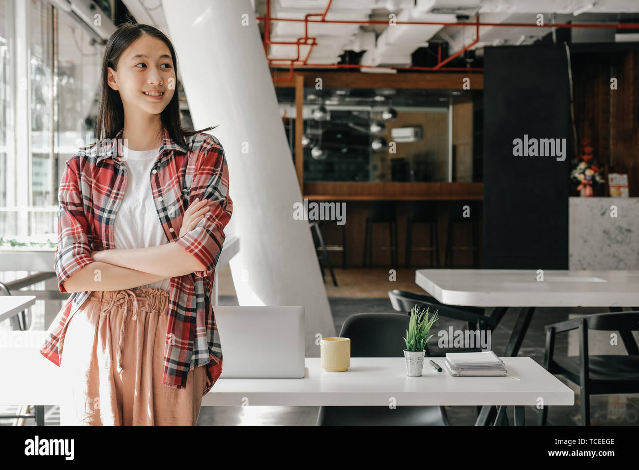 asian teenage girl teenager posing at co-working space Stock Photo - Alamy