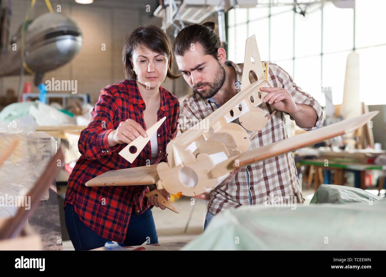 Positive couple enjoying their hobbies - modeling light airplanes in ...