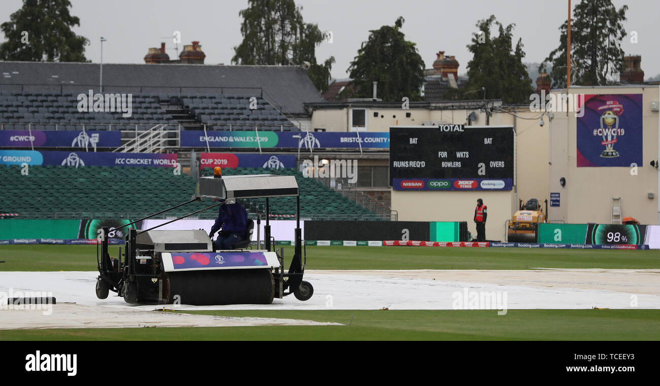 Ground staff work to clear water off the outfield before the ICC ...