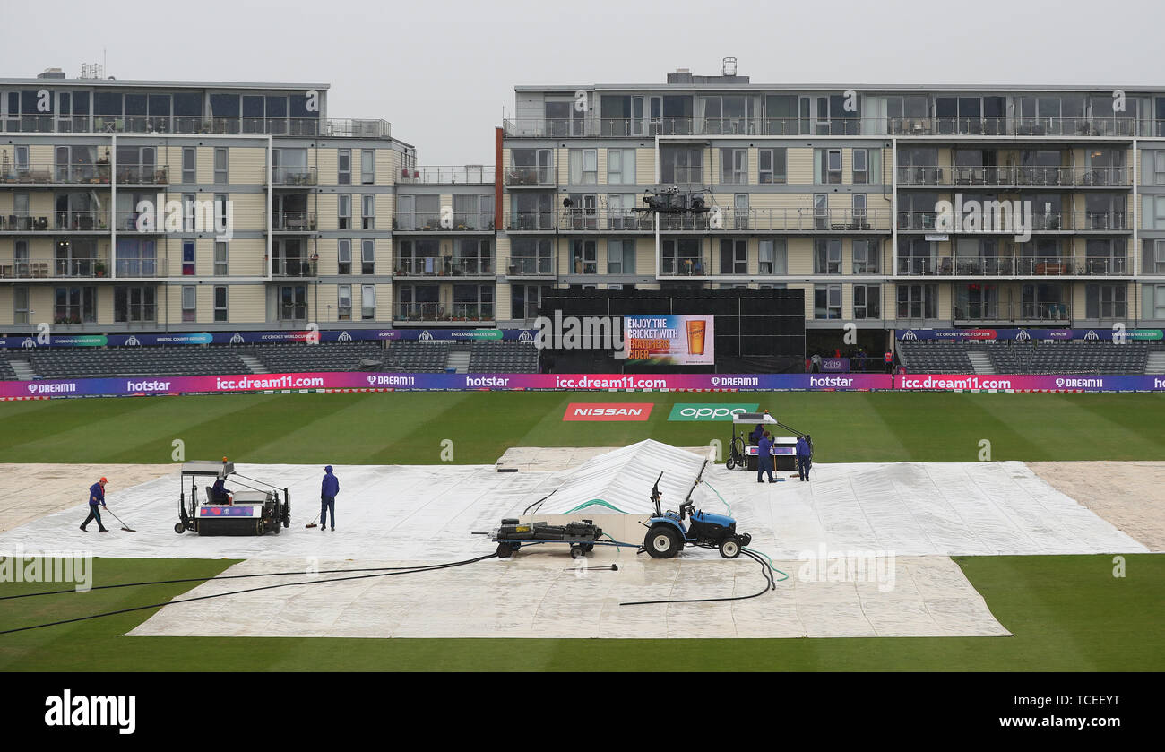 Ground staff work to clear water off the outfield before the ICC ...
