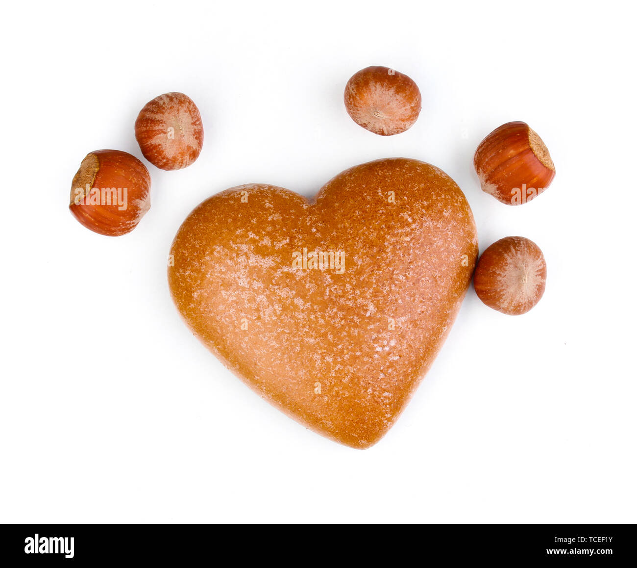Heart-shaped cookie with hazelnuts isolated on white Stock Photo - Alamy