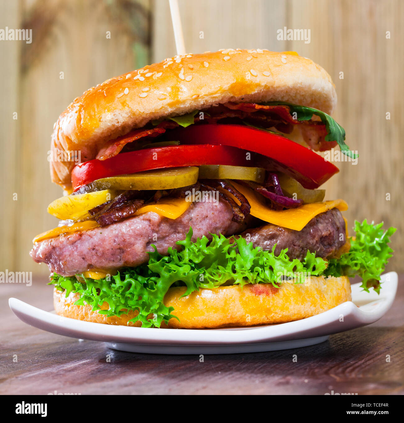 American double cheeseburger with meat rissole and vegetable salad ...
