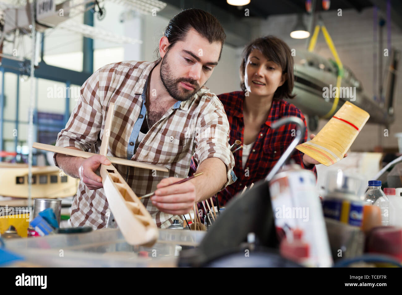 Positive couple enjoying their hobbies - modeling light airplanes in ...