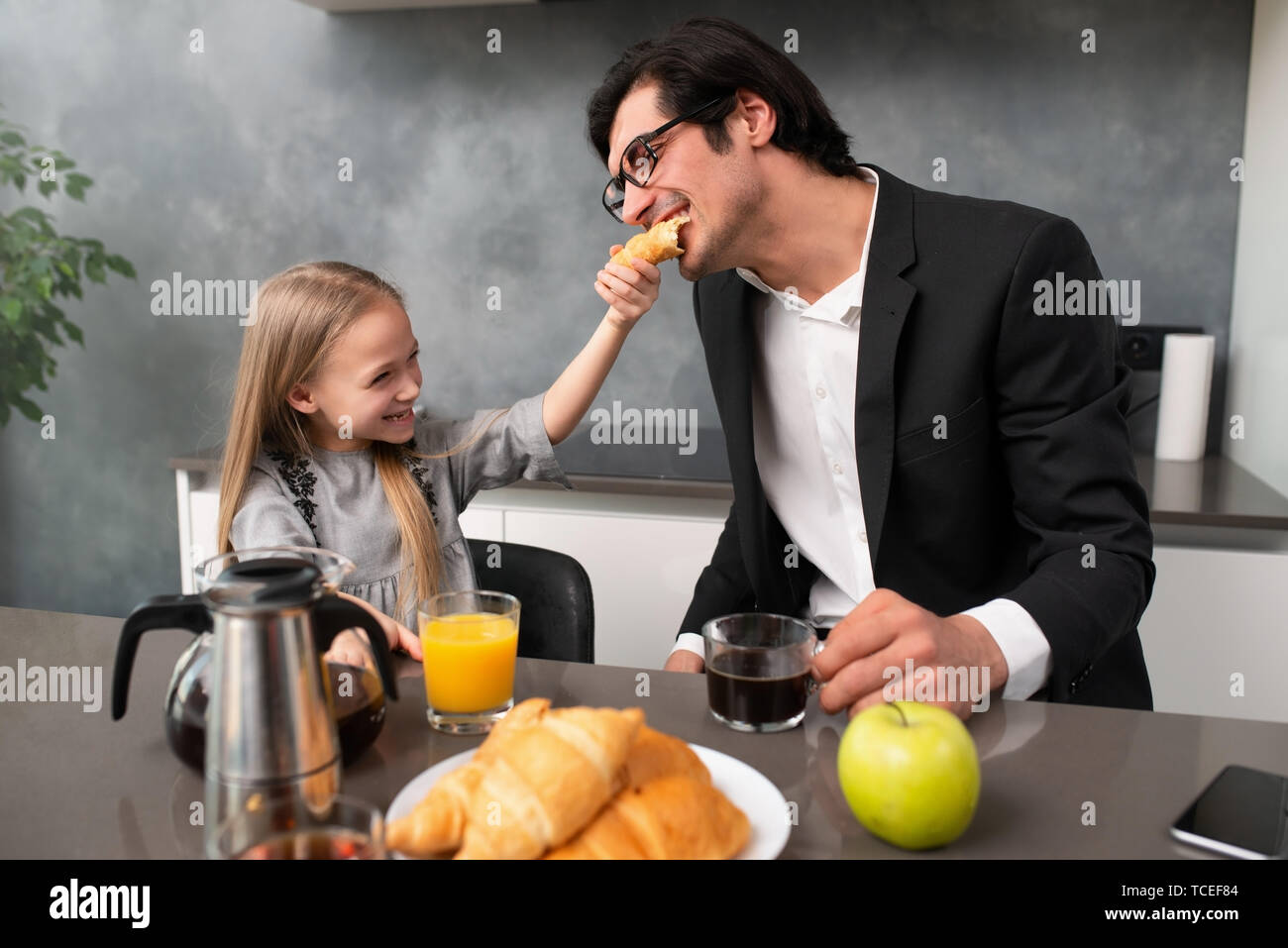 Happy family have a breakfast at home Stock Photo - Alamy
