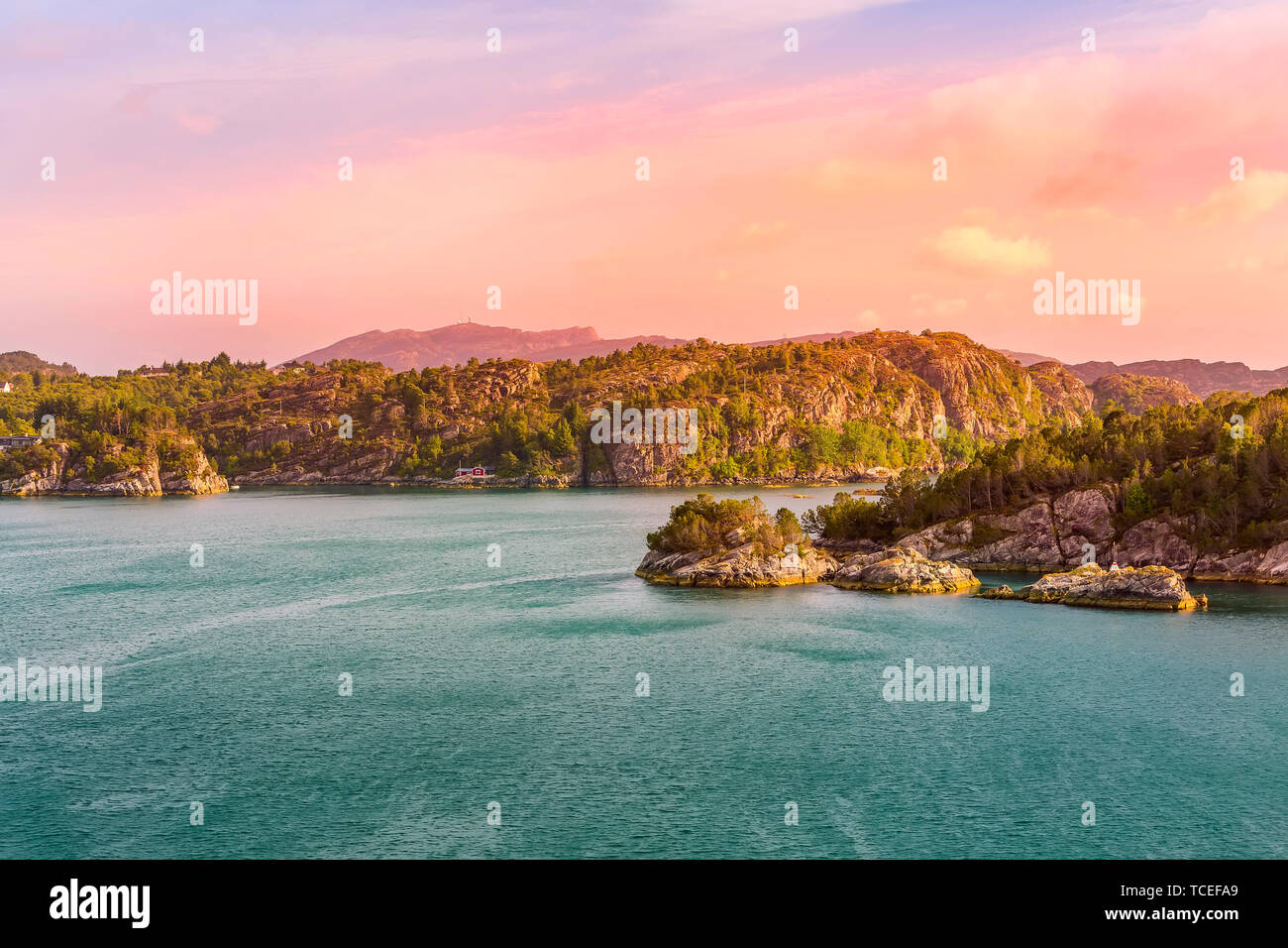 Norwegian colorful landscape with sunset over fjord and mountains ...