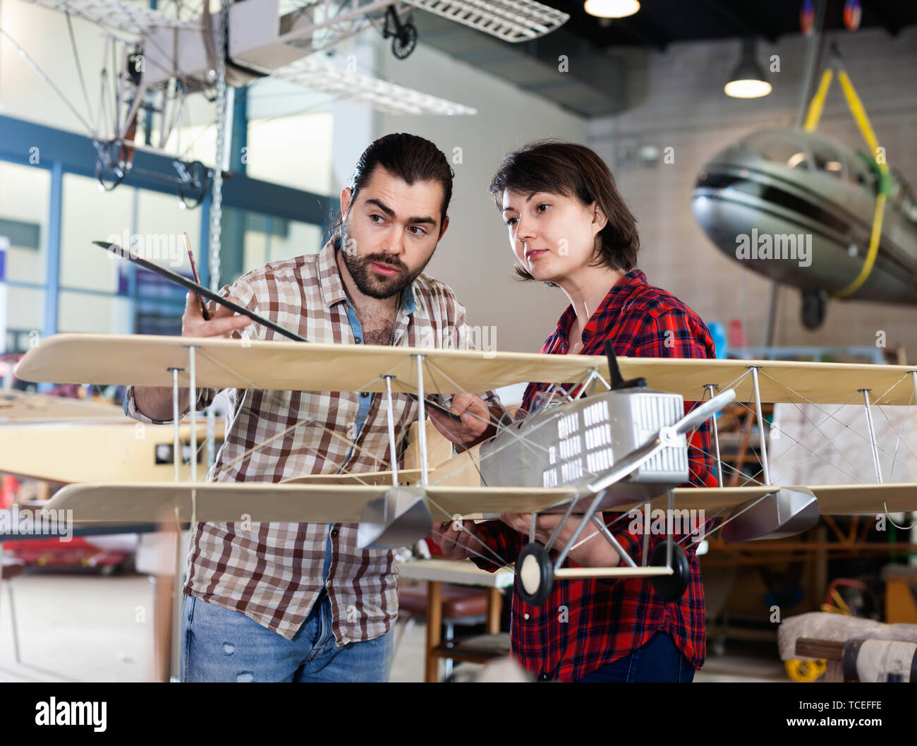 Positive diligent couple enjoying their hobbies - modeling light ...