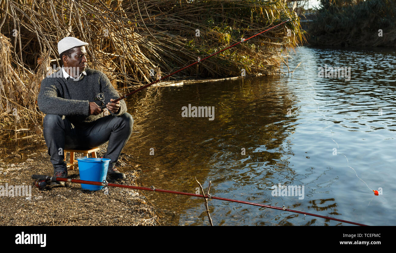 Man Sitting On Bucket Fishing High Resolution Stock Photography and ...