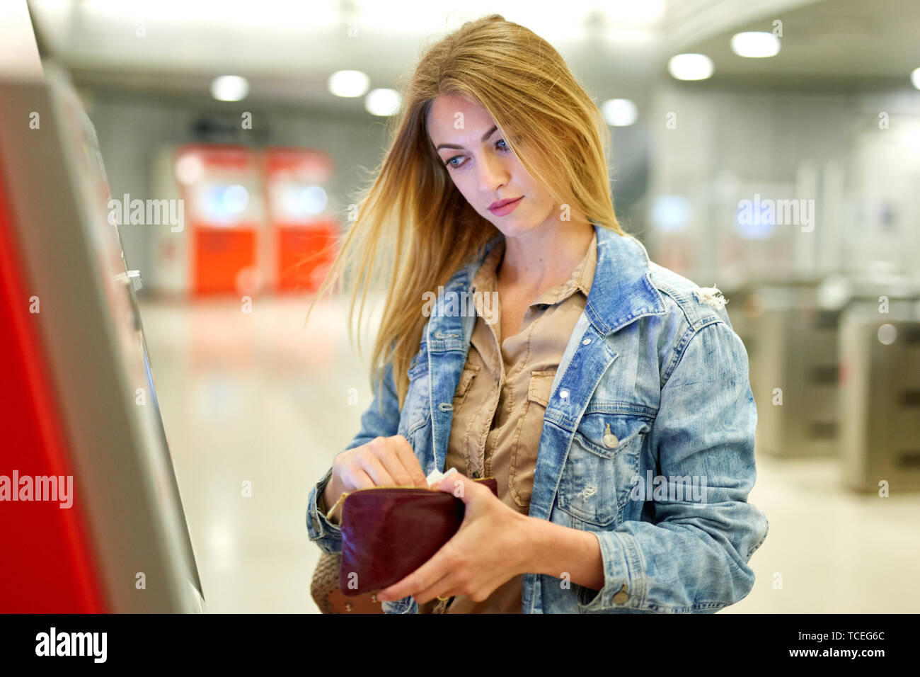 Nice woman traveler buying ticket in subway at ticket vending machine ...