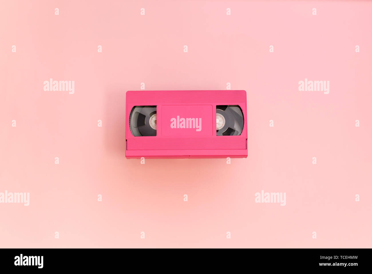 Pink video cassette tape on pink background Stock Photo - Alamy