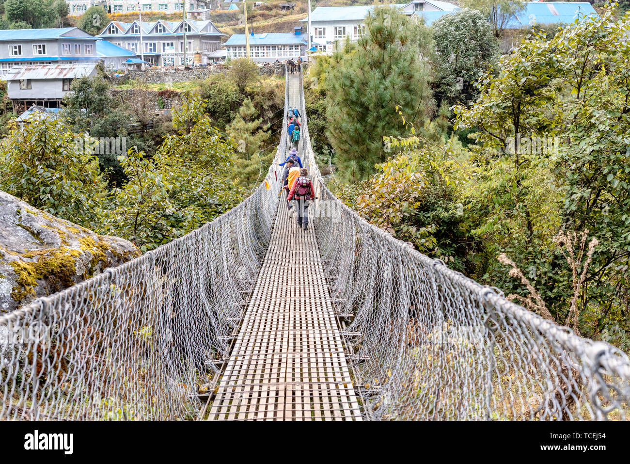 Trekkers Crossing Suspension Bridge On Everest Base Camp Trek Between Trekkers Crossing Suspension Bridge On Everest Base Camp Trek Between