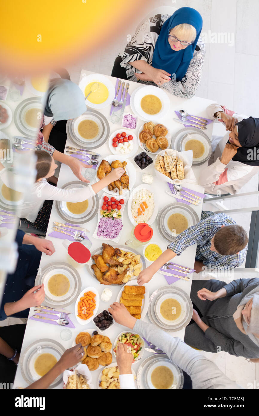 top view of modern multiethnic muslim family enjoying eating iftar ...
