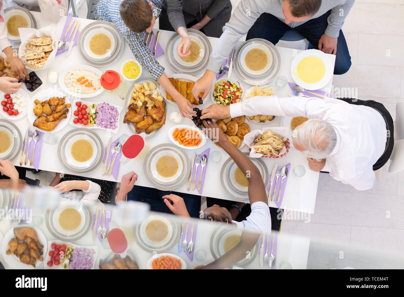 top view of modern multiethnic muslim family enjoying eating iftar ...