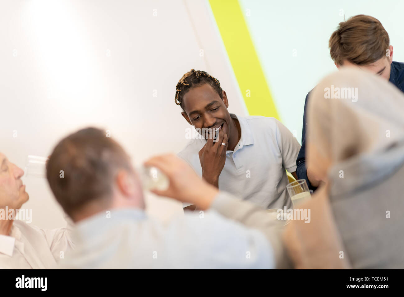 african american man enjoying iftar dinner together with modern ...