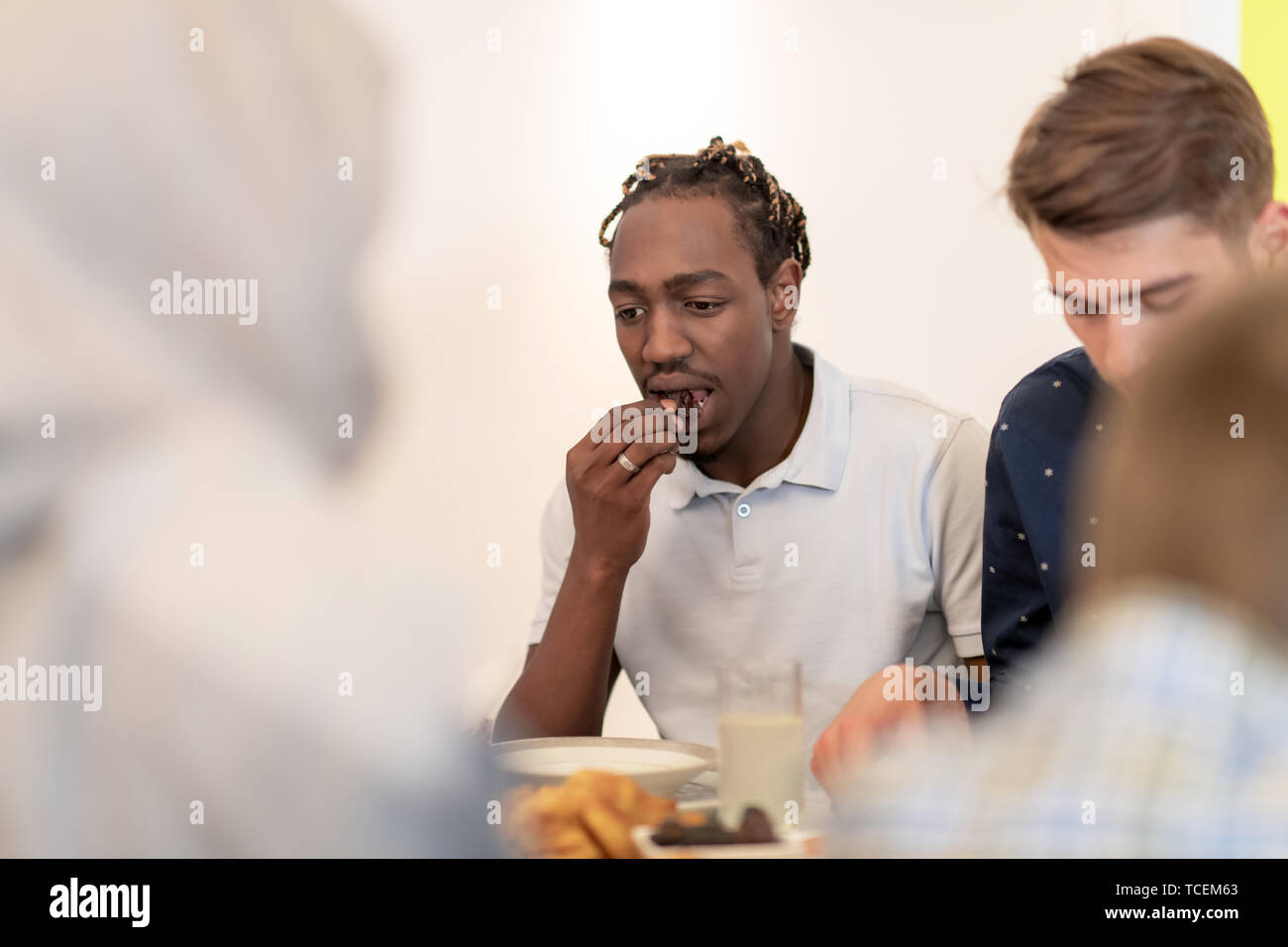 african american man enjoying iftar dinner together with modern ...