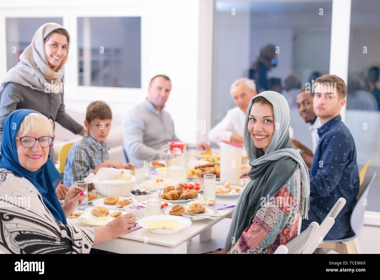 modern multiethnic muslim family enjoying eating iftar dinner together ...