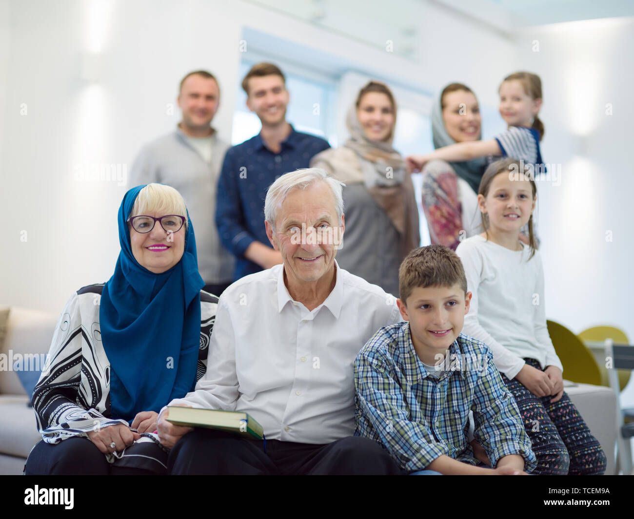 several generations portrait of happy modern muslim family before iftar ...