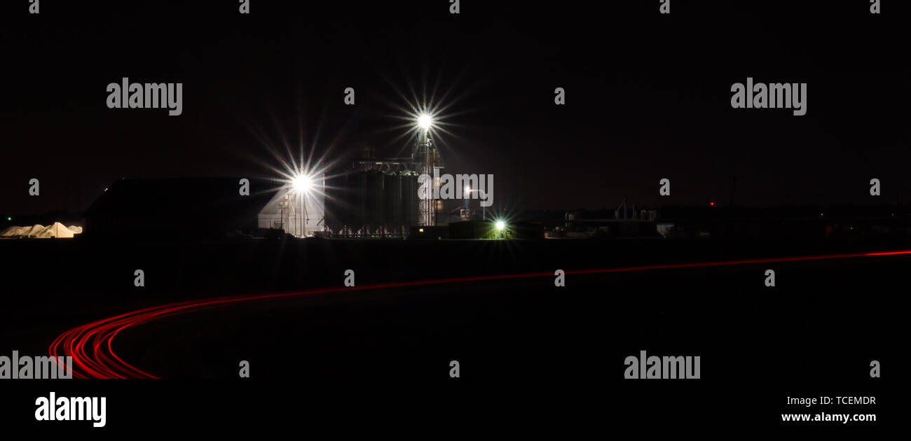 Rice silos and mill at night working through the night Stock Photo - Alamy
