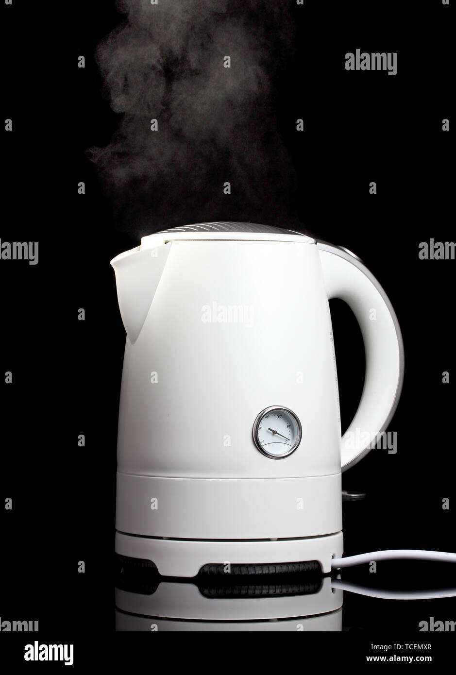 White electric kettle on black Stock Photo - Alamy