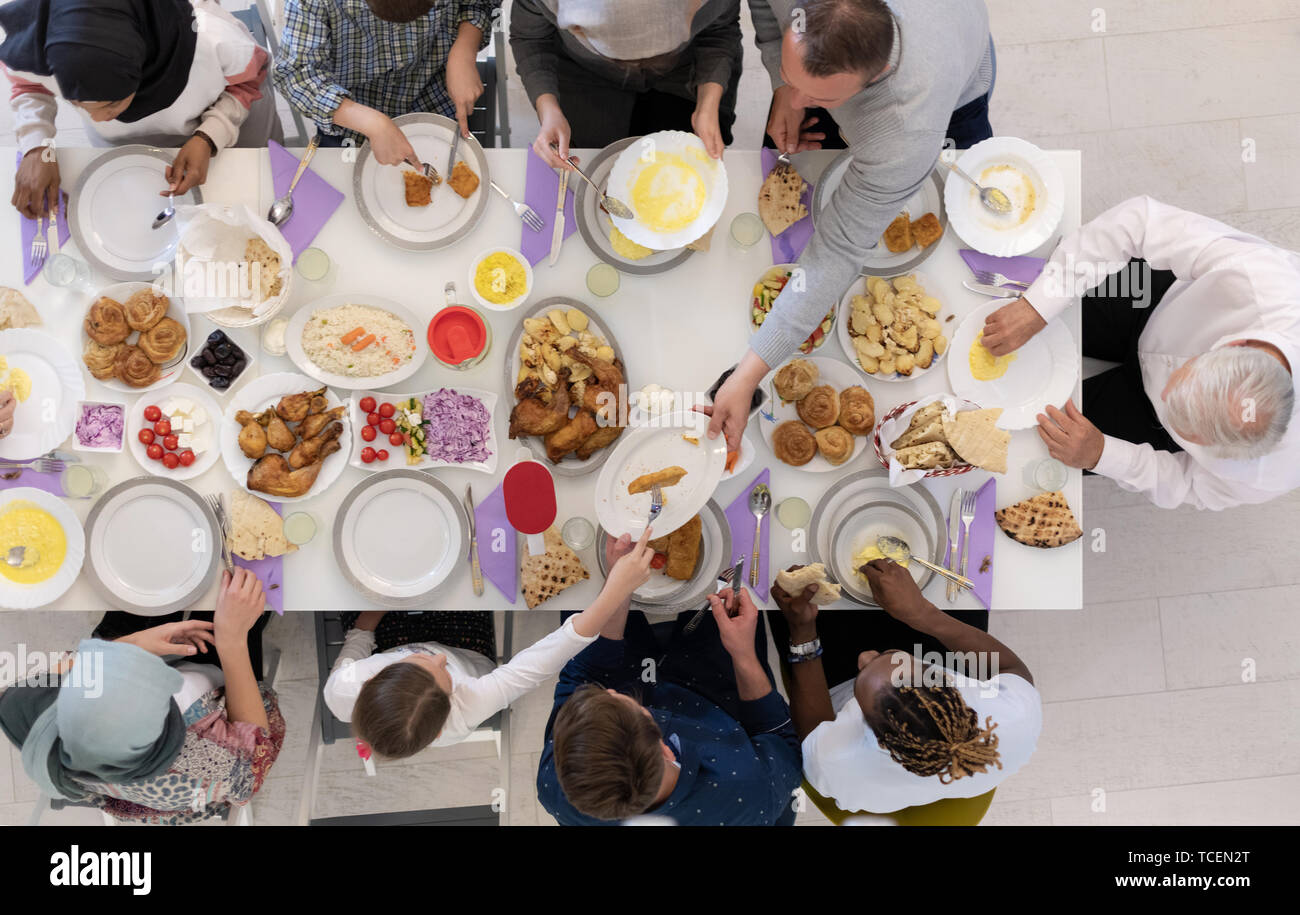 top view of modern multiethnic muslim family enjoying eating iftar ...