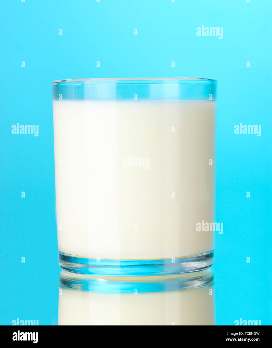 Glass of milk on blue Stock Photo - Alamy