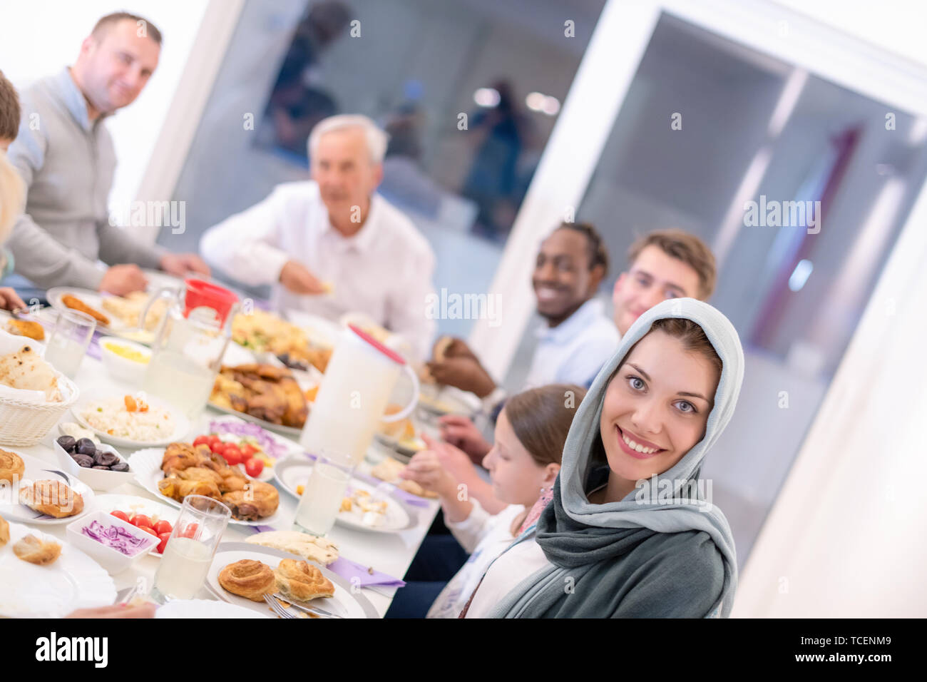 modern multiethnic muslim family enjoying eating iftar dinner together ...