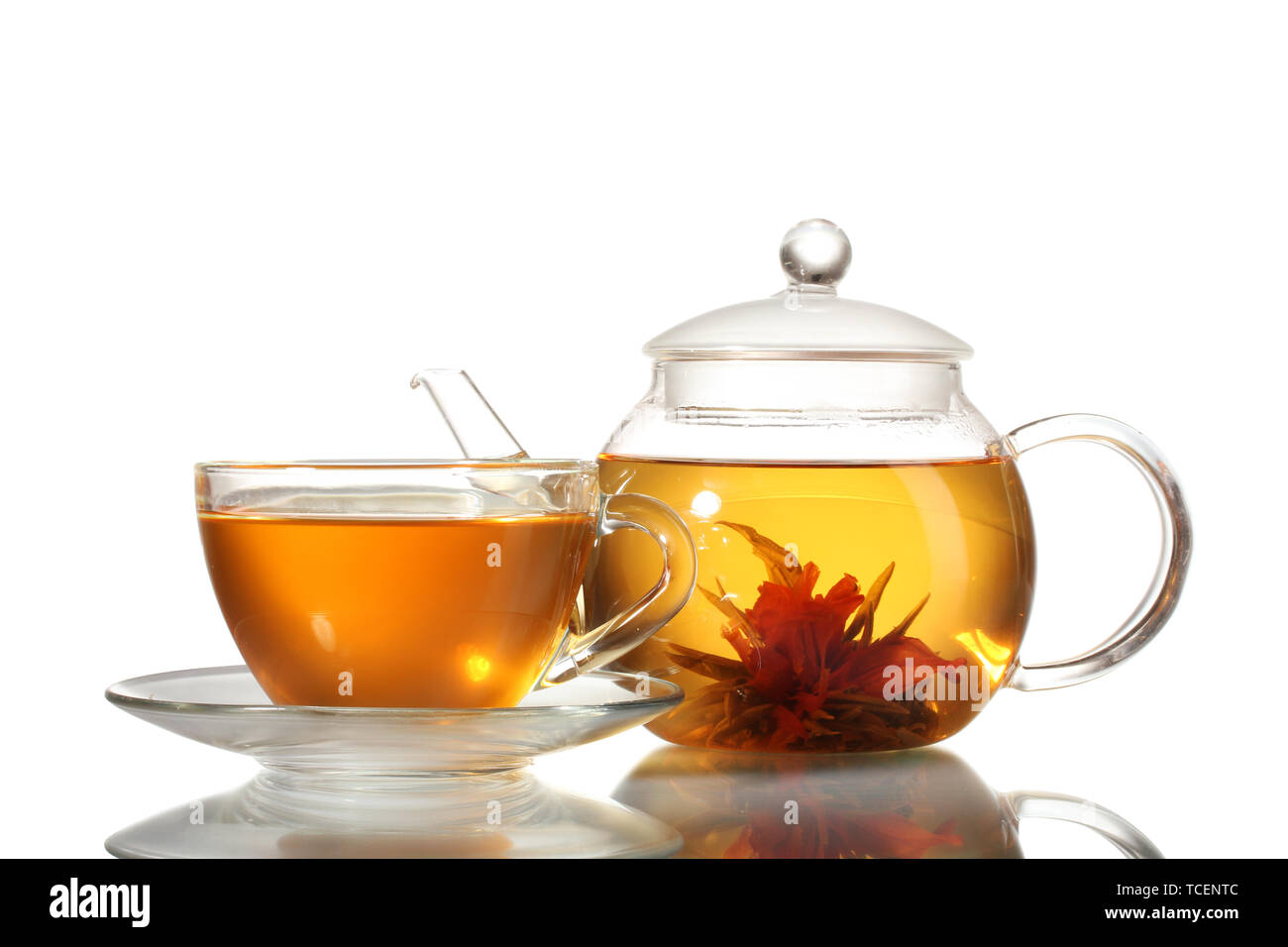 exotic green tea with flowers in glass teapot and cup isolated on white ...